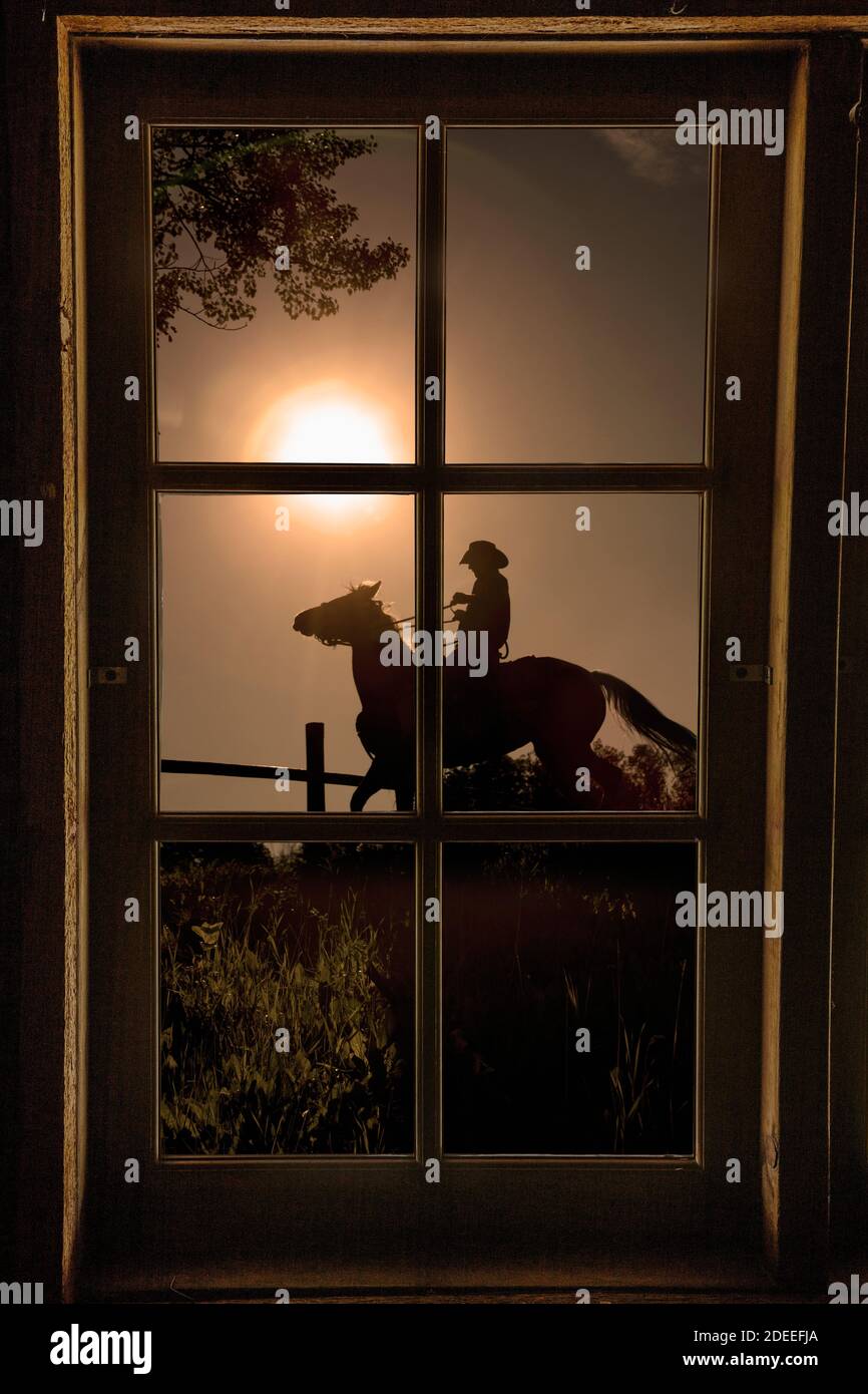 Cowboy through window Stock Photo - Alamy