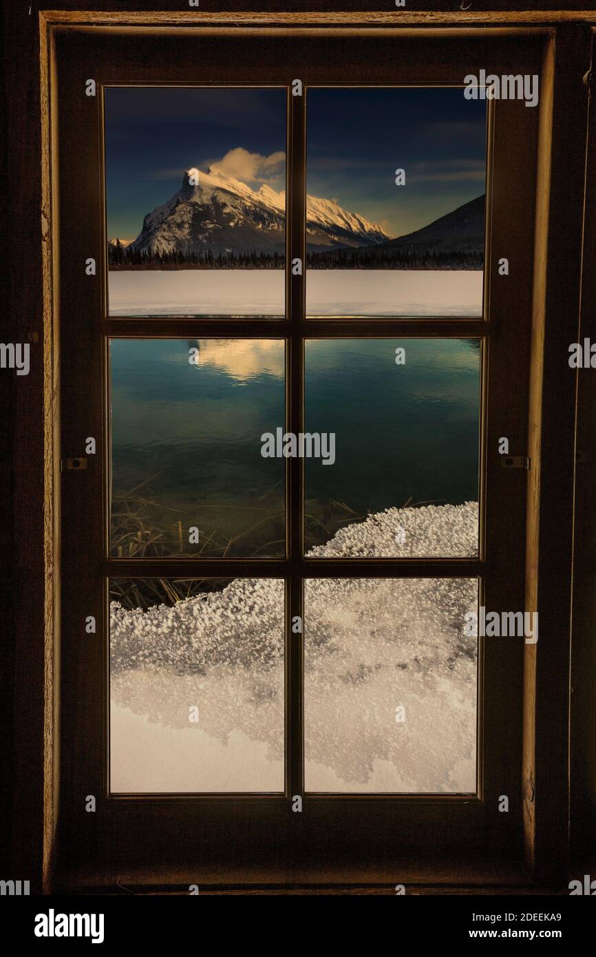 Ice and snow on mountain lake in Banff Alberta from window frame Stock ...