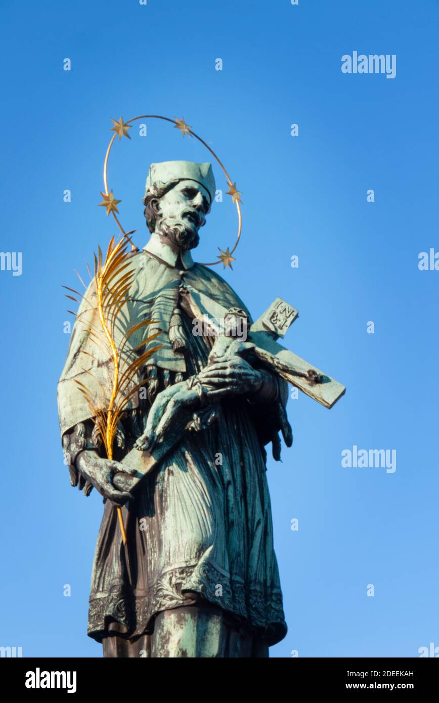 Statues of religious figures and saints line the Charles Bridge over ...