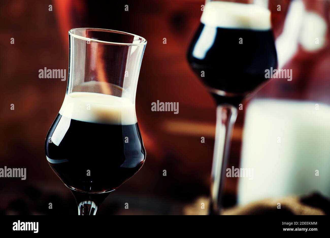 Two-layer cocktail with coffee liqueur, vintage wood background ...