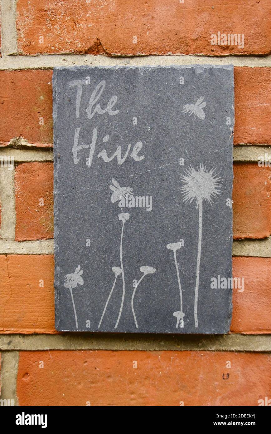 Slate bee hive artwork sign with "The Hive" writing and flowers and ...