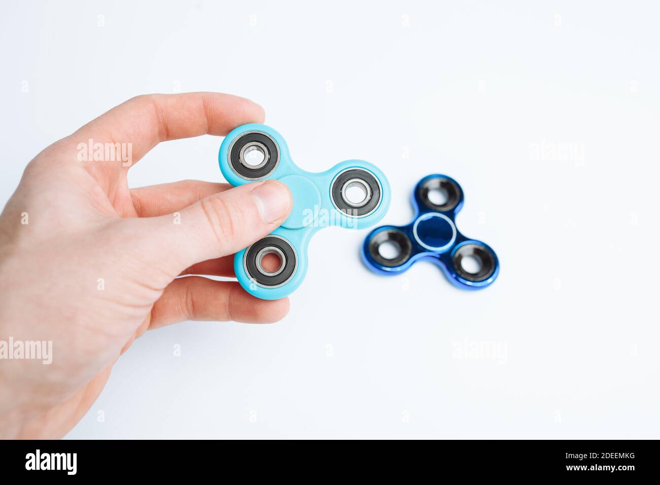 Man spinning spinner, fidget toys blue blue, advertising Stock Photo ...
