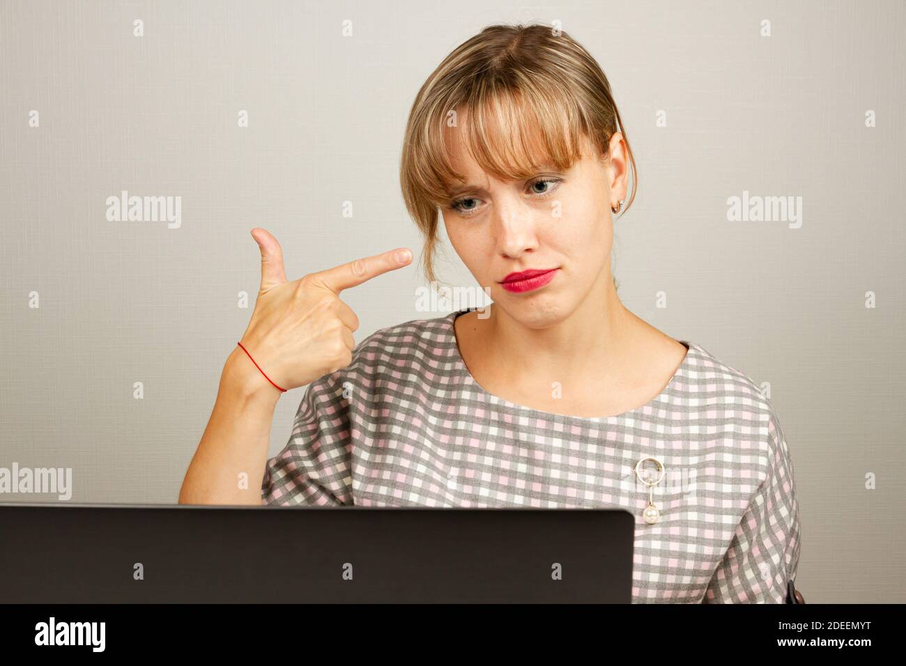 beautiful young girl thinking in the office at the computer Stock Photo ...