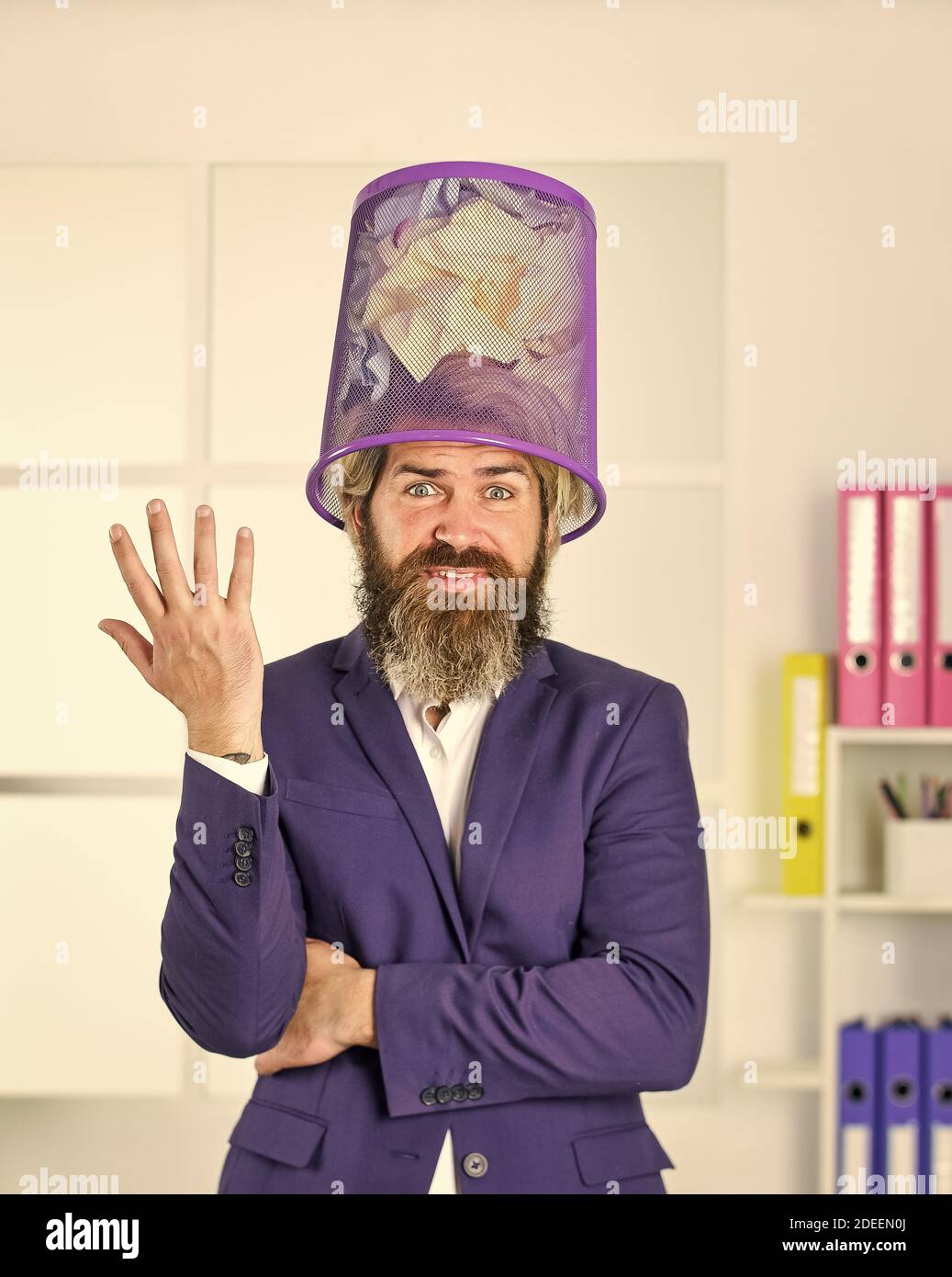 looking so funny. man in office look for lost note in paper bin ...