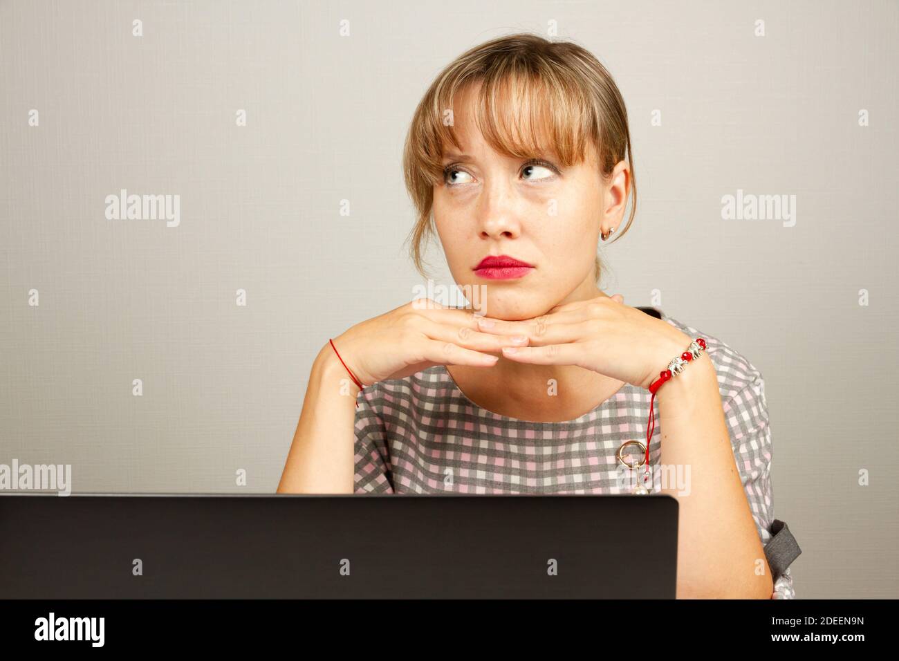 beautiful young girl thinking in the office at the computer Stock Photo ...