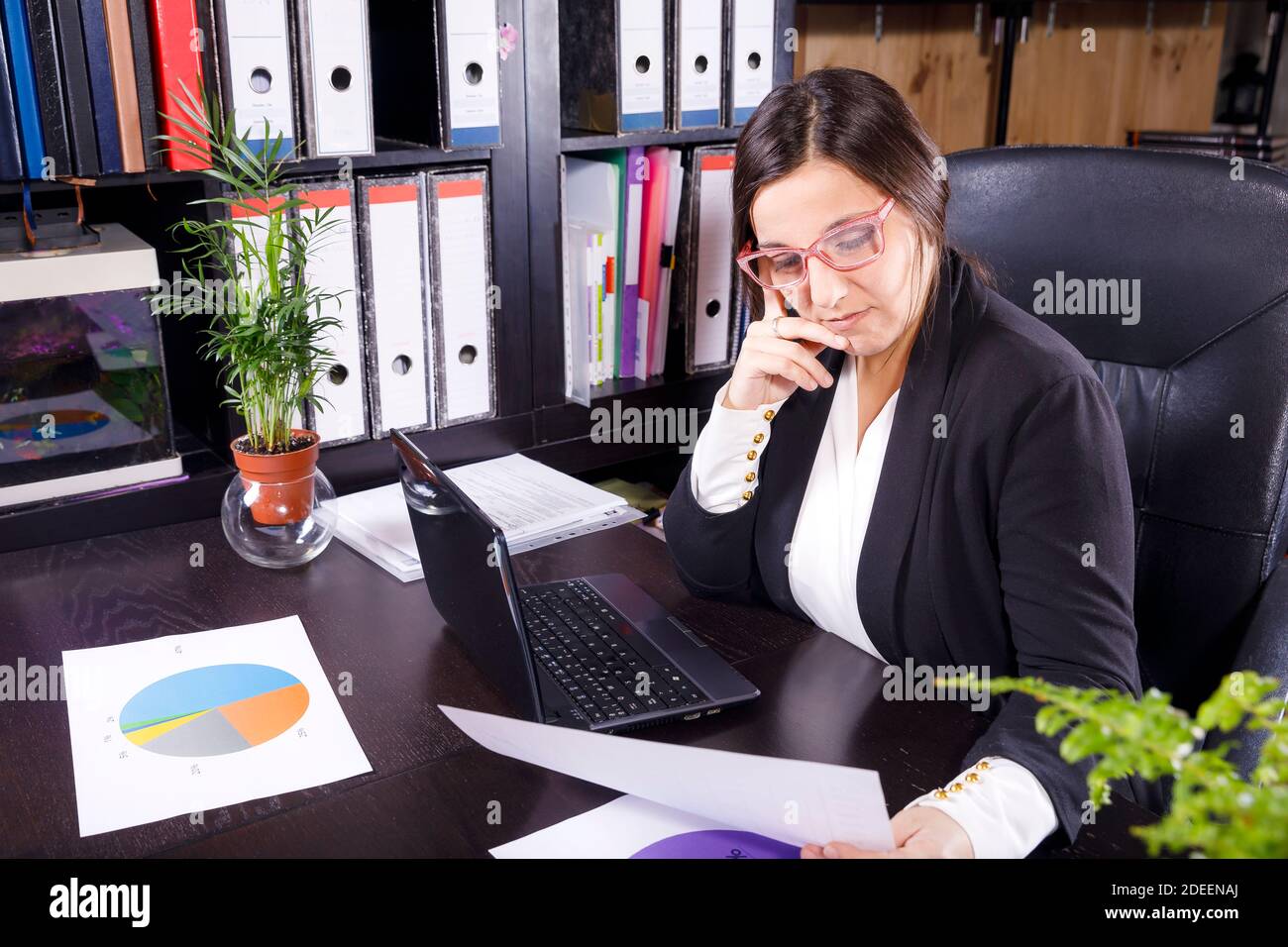 Young girl with glasses and office worker dressed in a suit sitting at ...