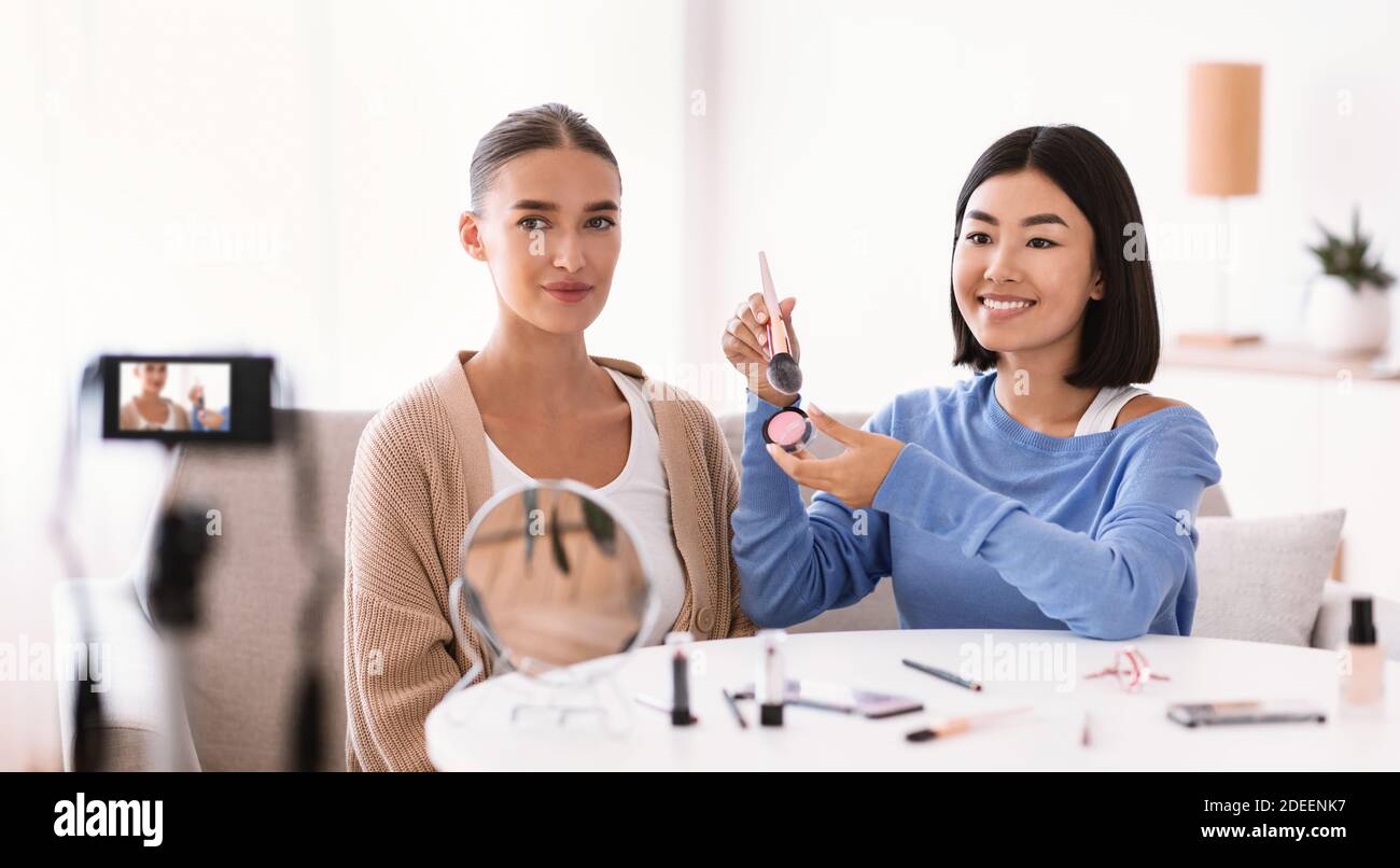 Asian Woman Doing Makeup For Her Model Stock Photo - Alamy