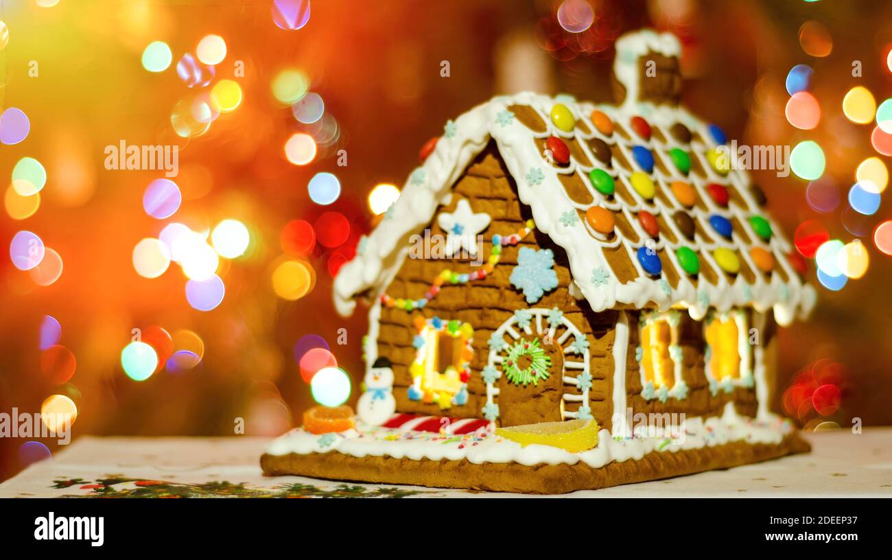gingerbread house with blurred garland lights background Stock Photo ...