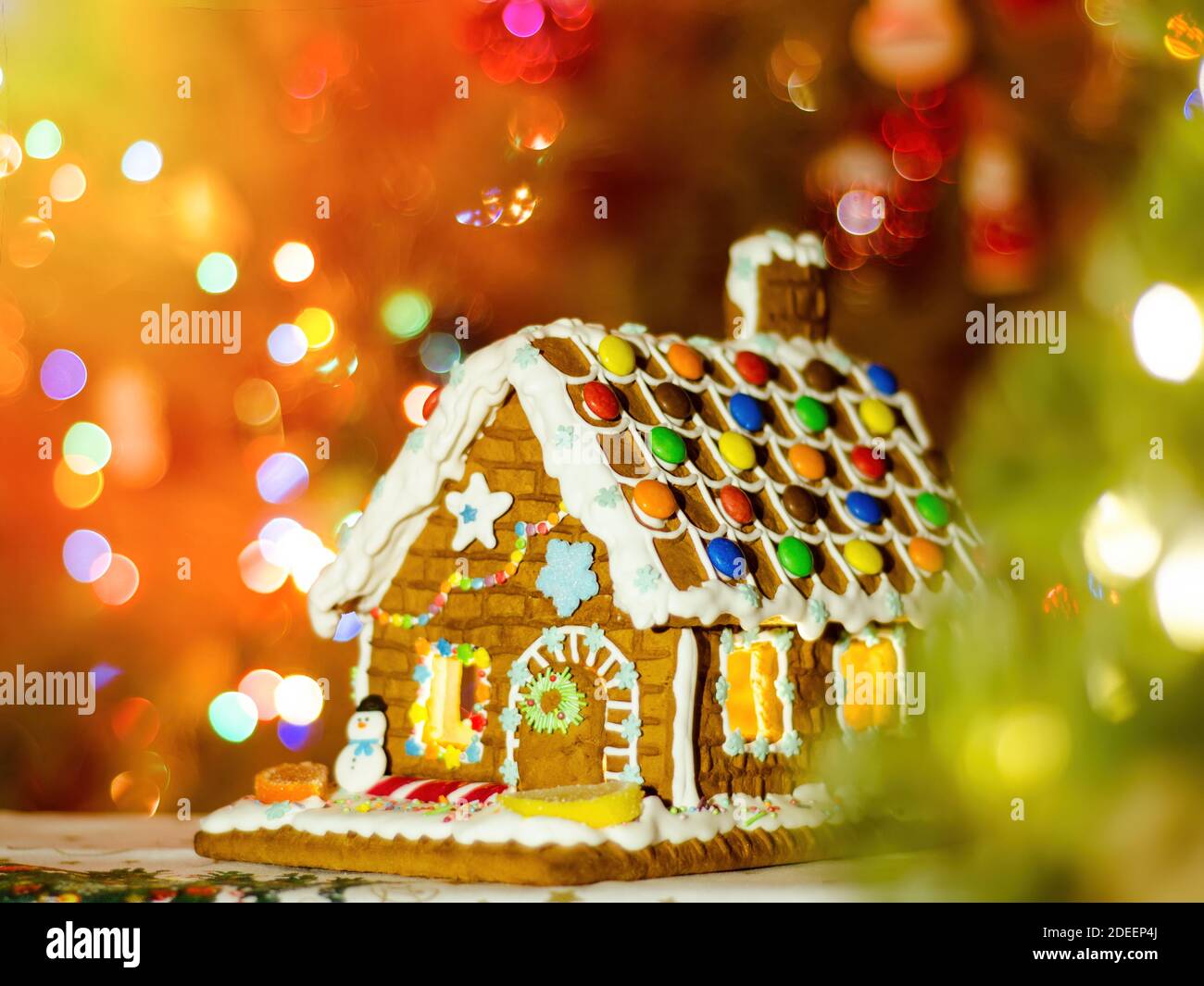 gingerbread house with blurred garland lights background Stock Photo ...