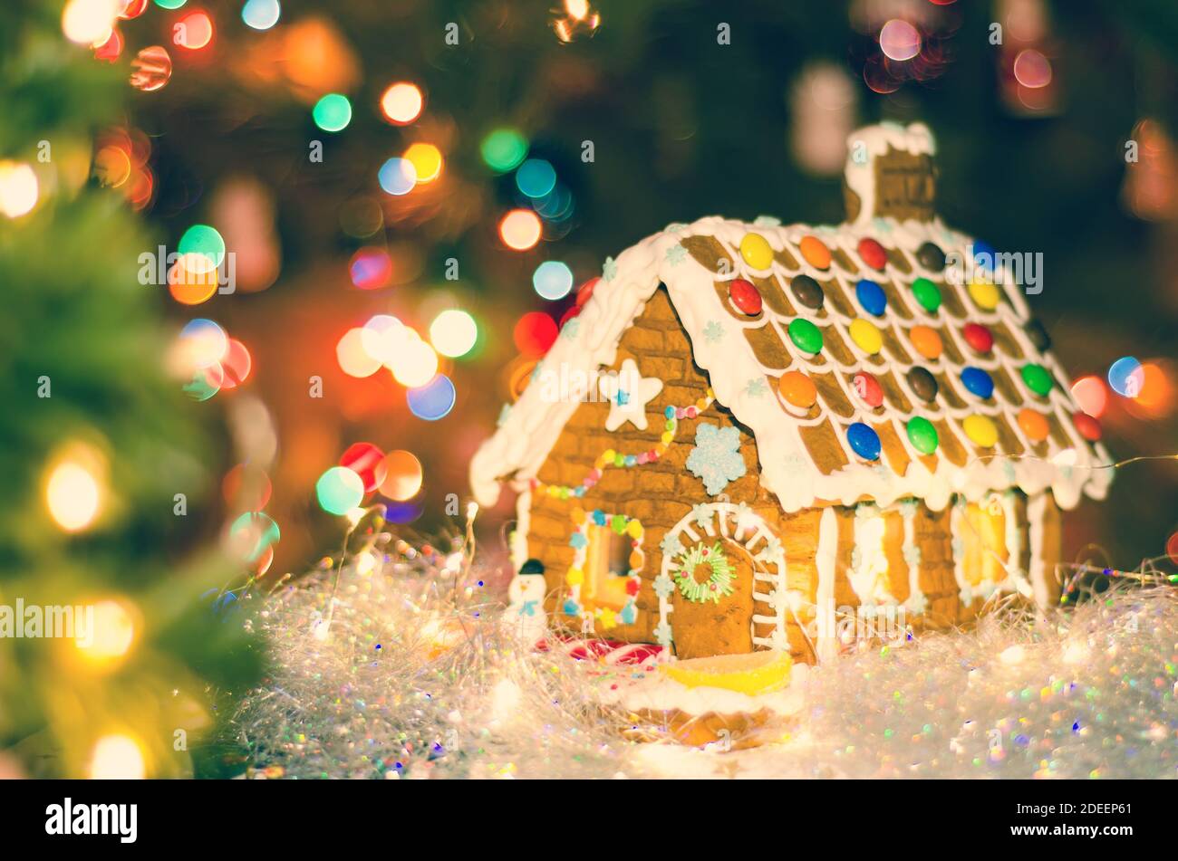 gingerbread house with blurred garland lights background Stock Photo ...