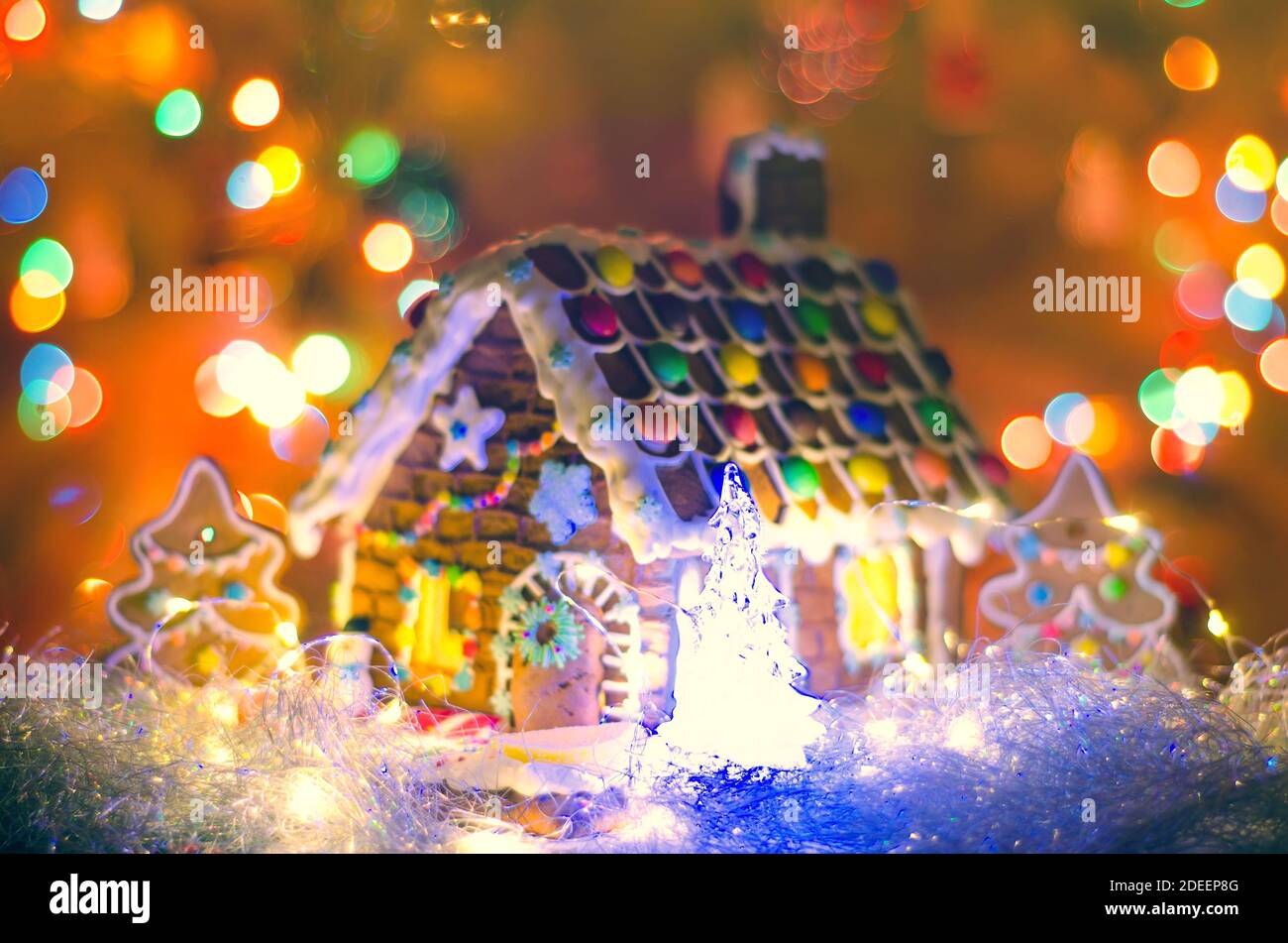 gingerbread house with blurred garland lights background Stock Photo ...