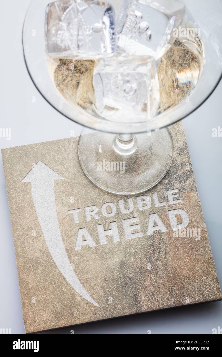 Trouble ahead with martini glass Stock Photo - Alamy