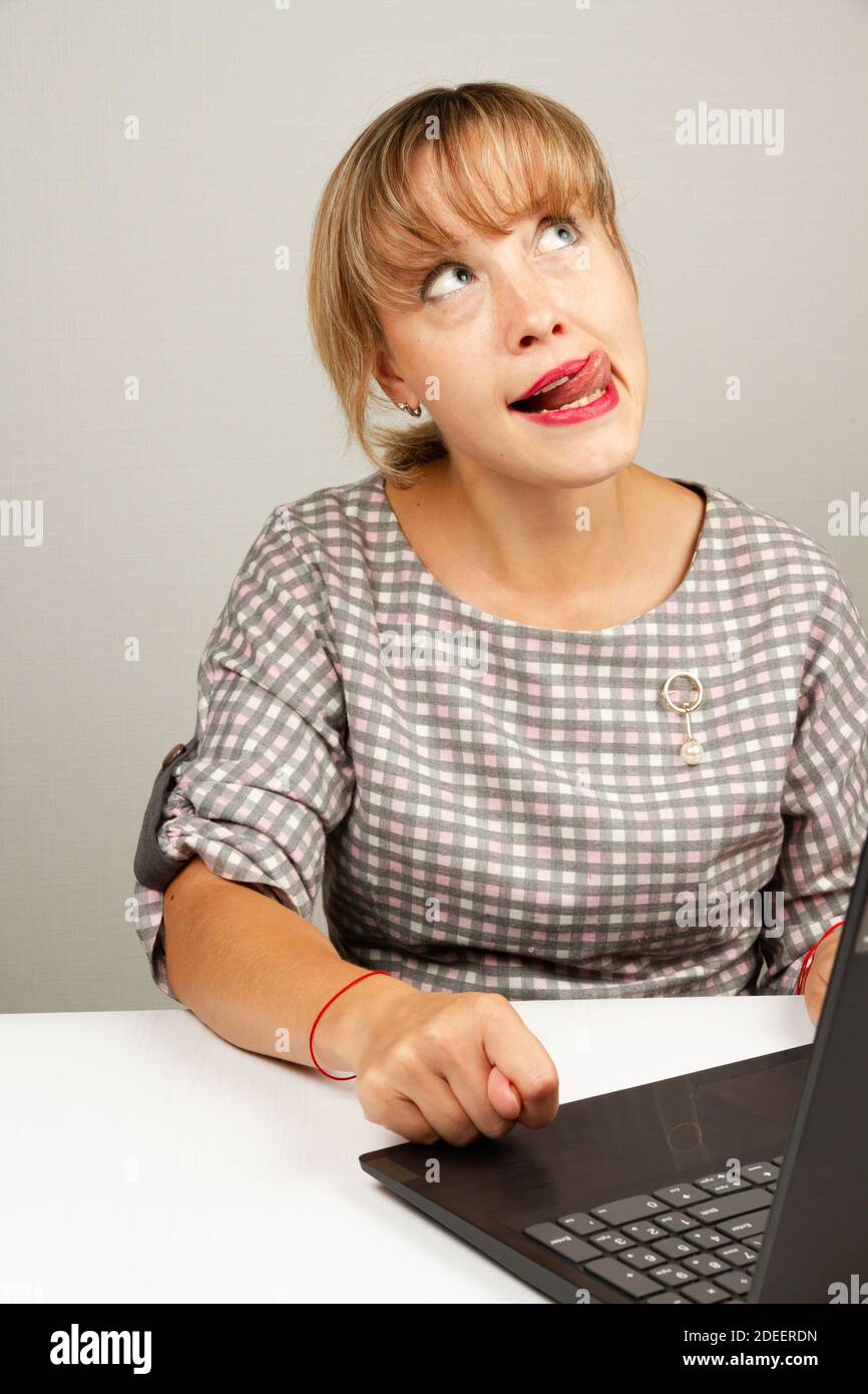 beautiful young girl thinking in the office at the computer Stock Photo ...