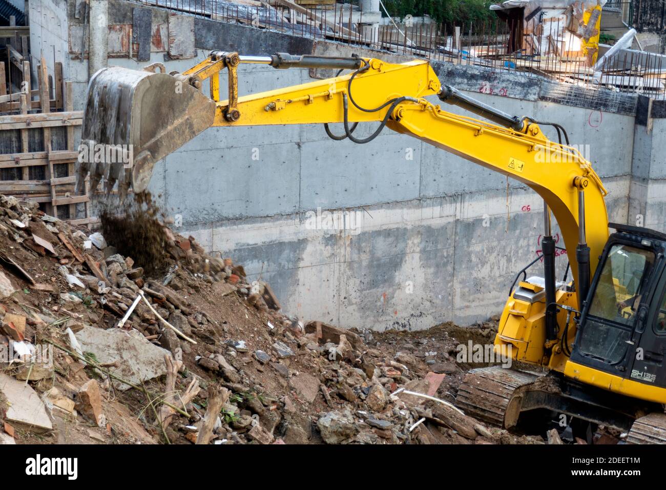 Urban transformation.Heavy equipment being used to tear tearing down ...