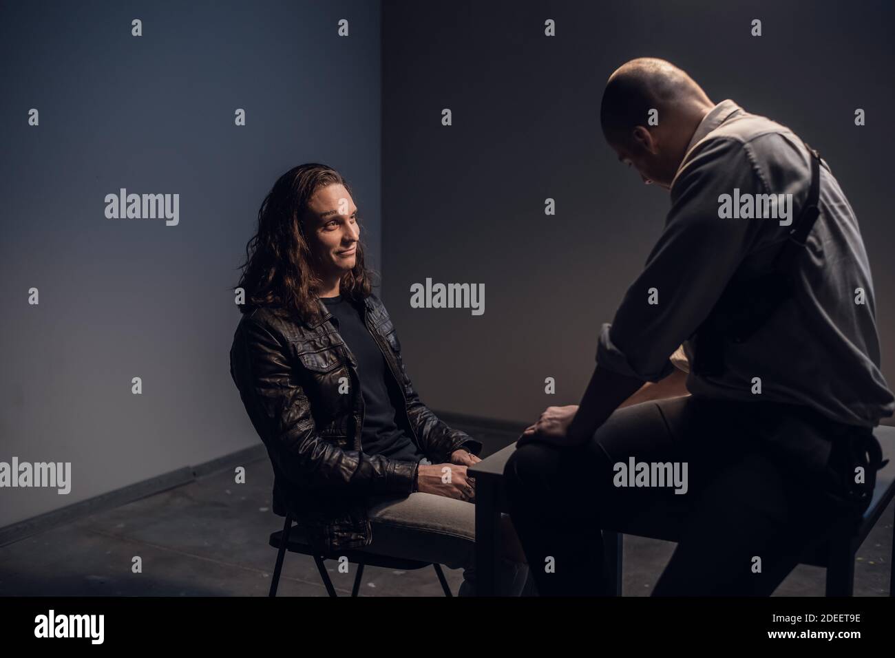 A Police Detective Suspects A White Man Of Committing A Crime Conducts