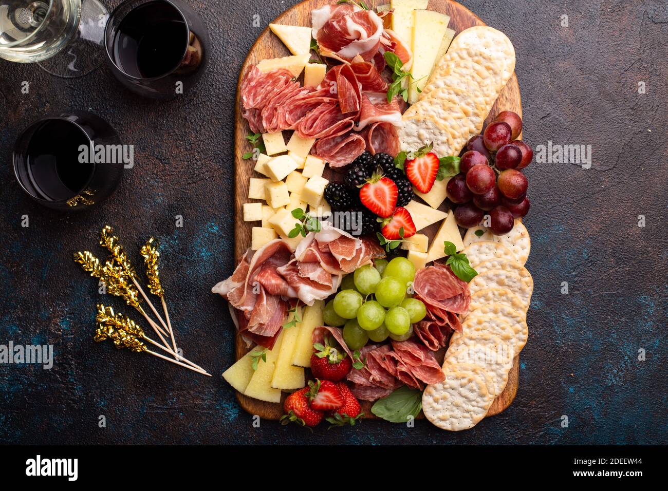 Cheese board on dark background Stock Photo - Alamy