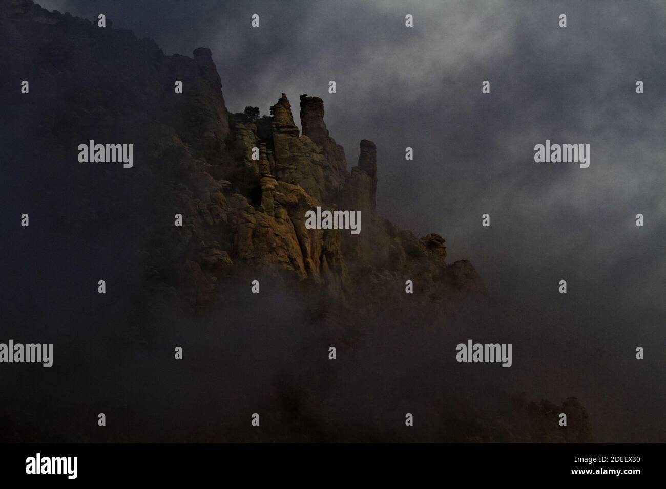 Dark clouds and shifting fog open to reveal rocky spires on Mount ...