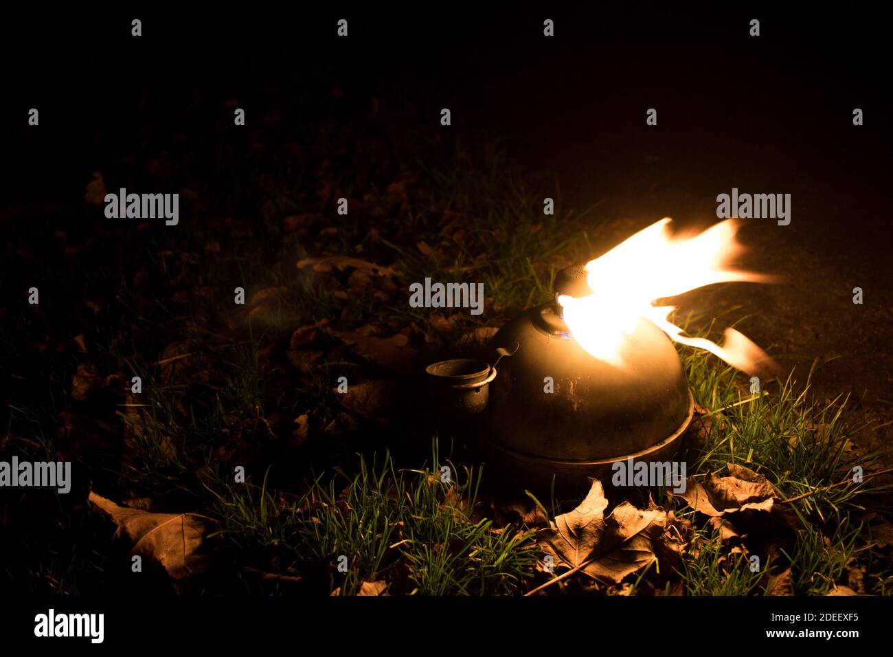 a burning oil lamp burning at night. The flames are dancing on the ...