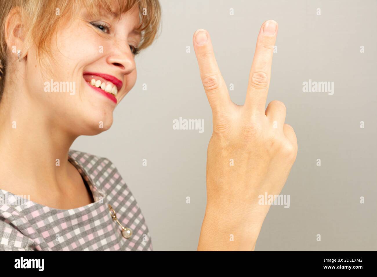 beautiful girl showing signs with her hands Stock Photo - Alamy