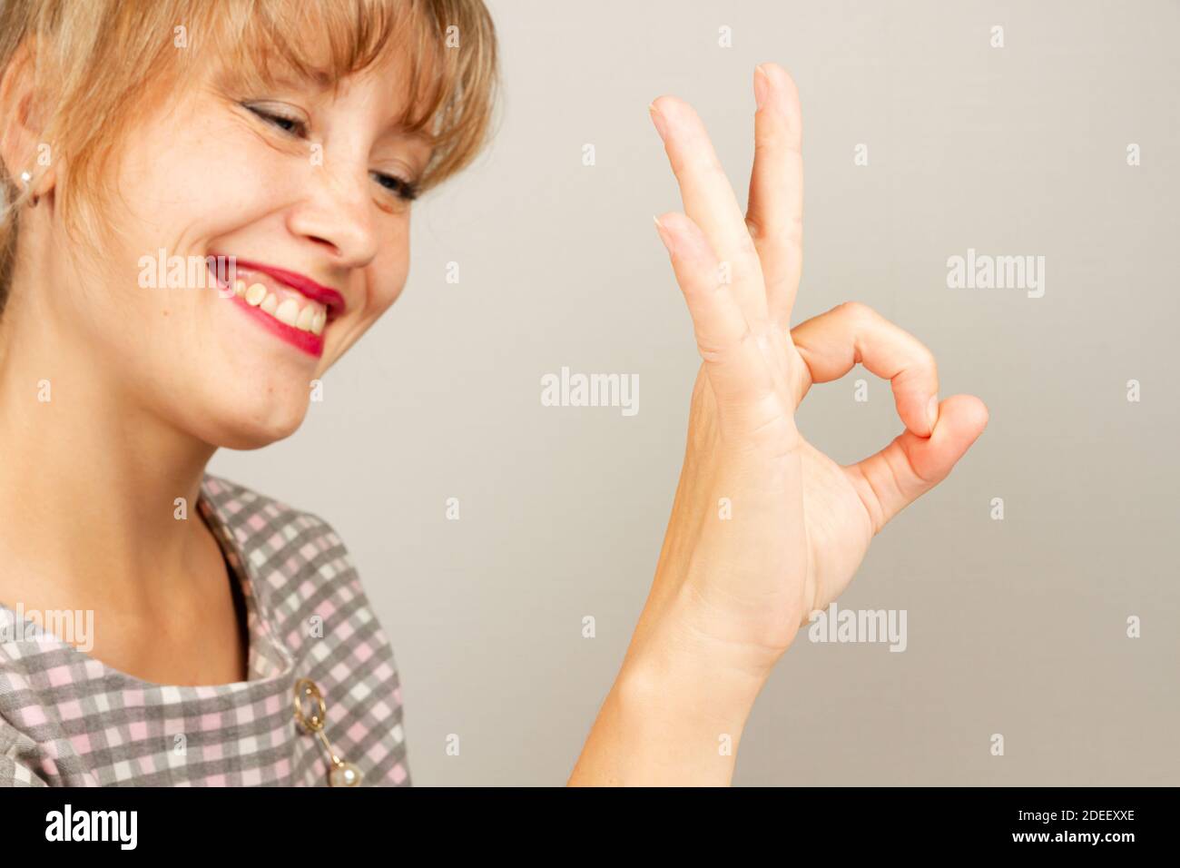 beautiful girl showing signs with her hands Stock Photo - Alamy
