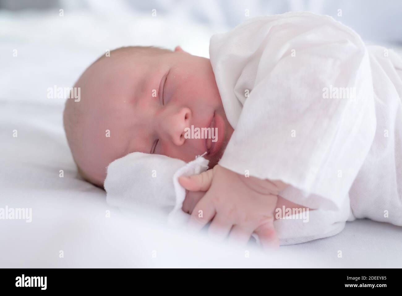 new born infant asleep in the blanket in delivery room Stock Photo - Alamy