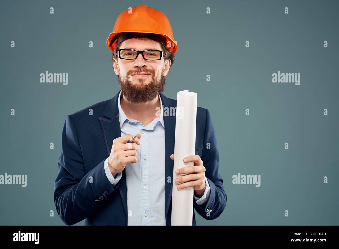 Male engineer wearing a suit in orange paint safety work drawings Stock ...