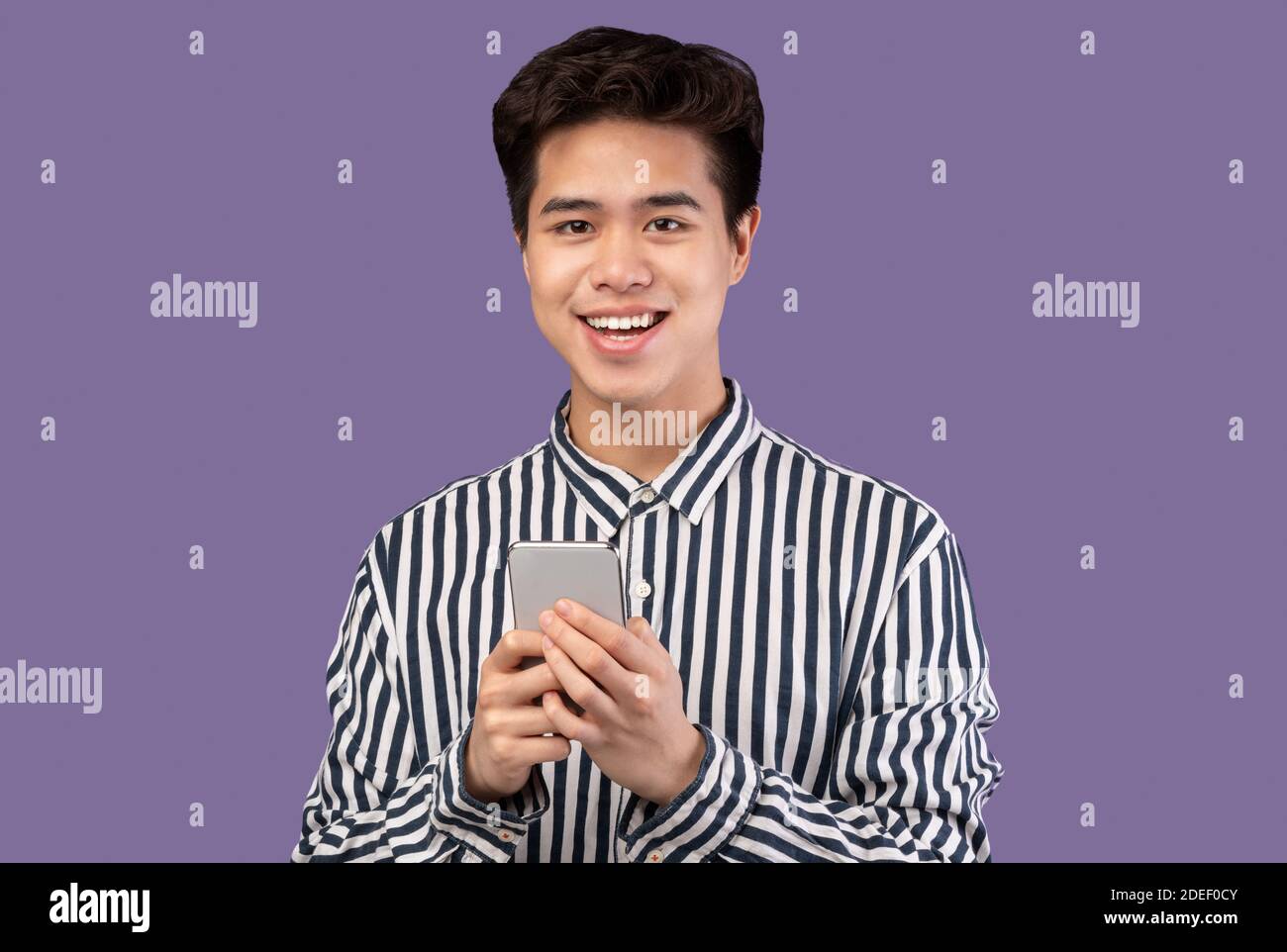 Positive asian man texting phone hi-res stock photography and images ...