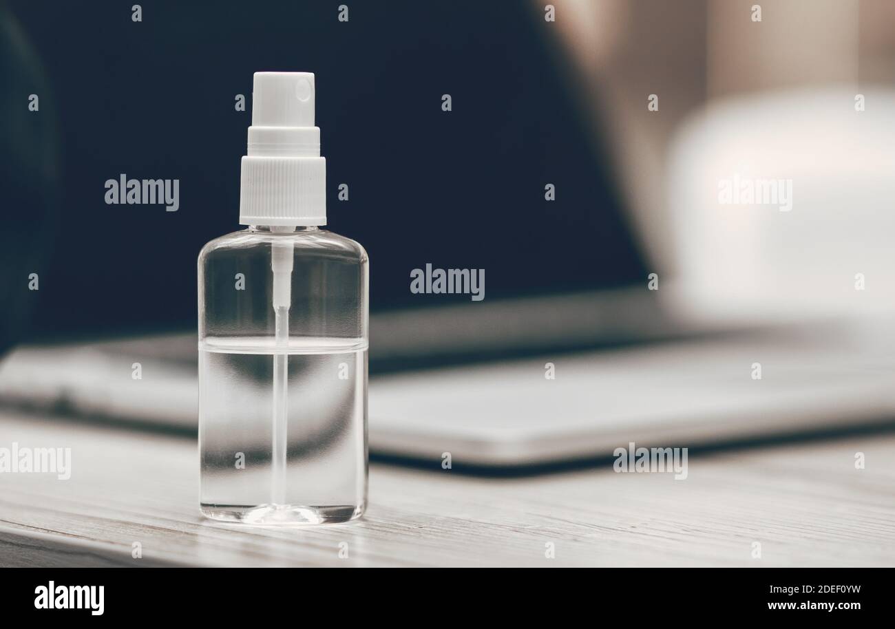 image of an antiseptic spray next to a laptop on the table Stock Photo ...