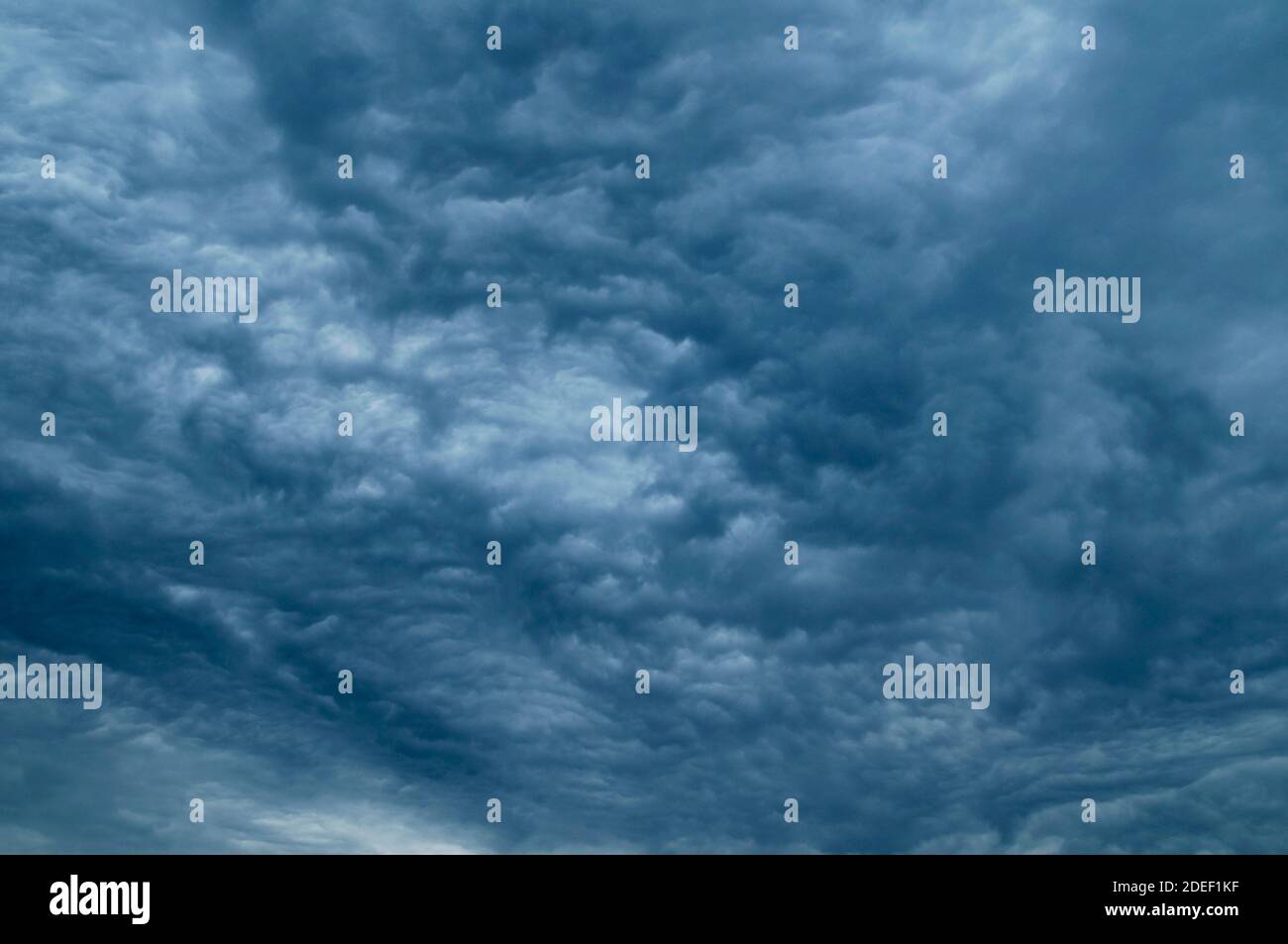 Dramatic dark blue sky with heavy clouds background Stock Photo - Alamy