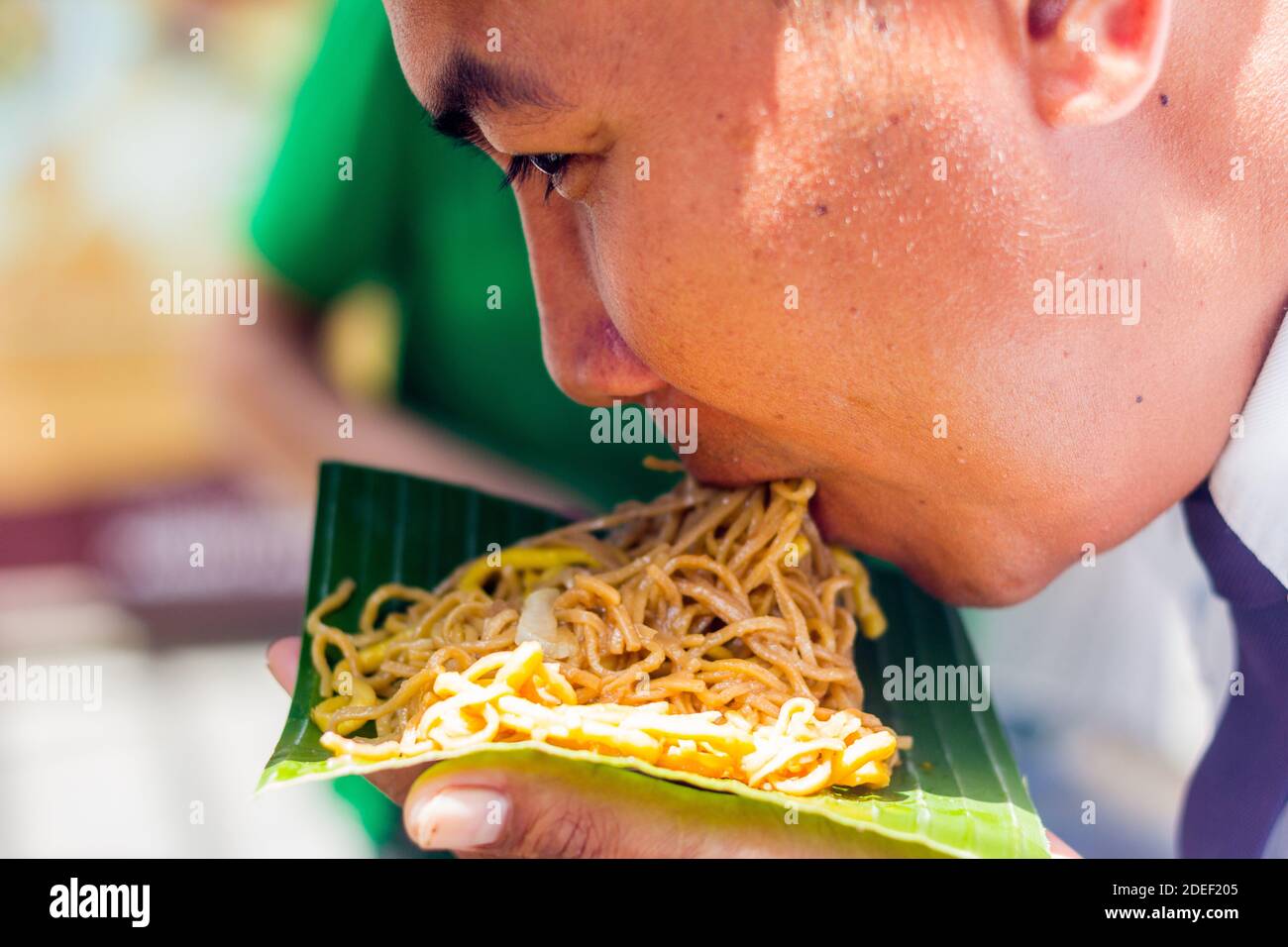 A man eats pansit habhab, a local delicacy in Lucban, Quezon ...