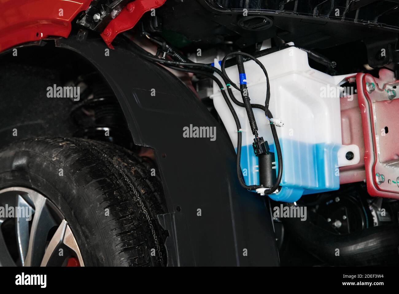 a tank with washer fluid and a motor for supplying fluid in the car ...