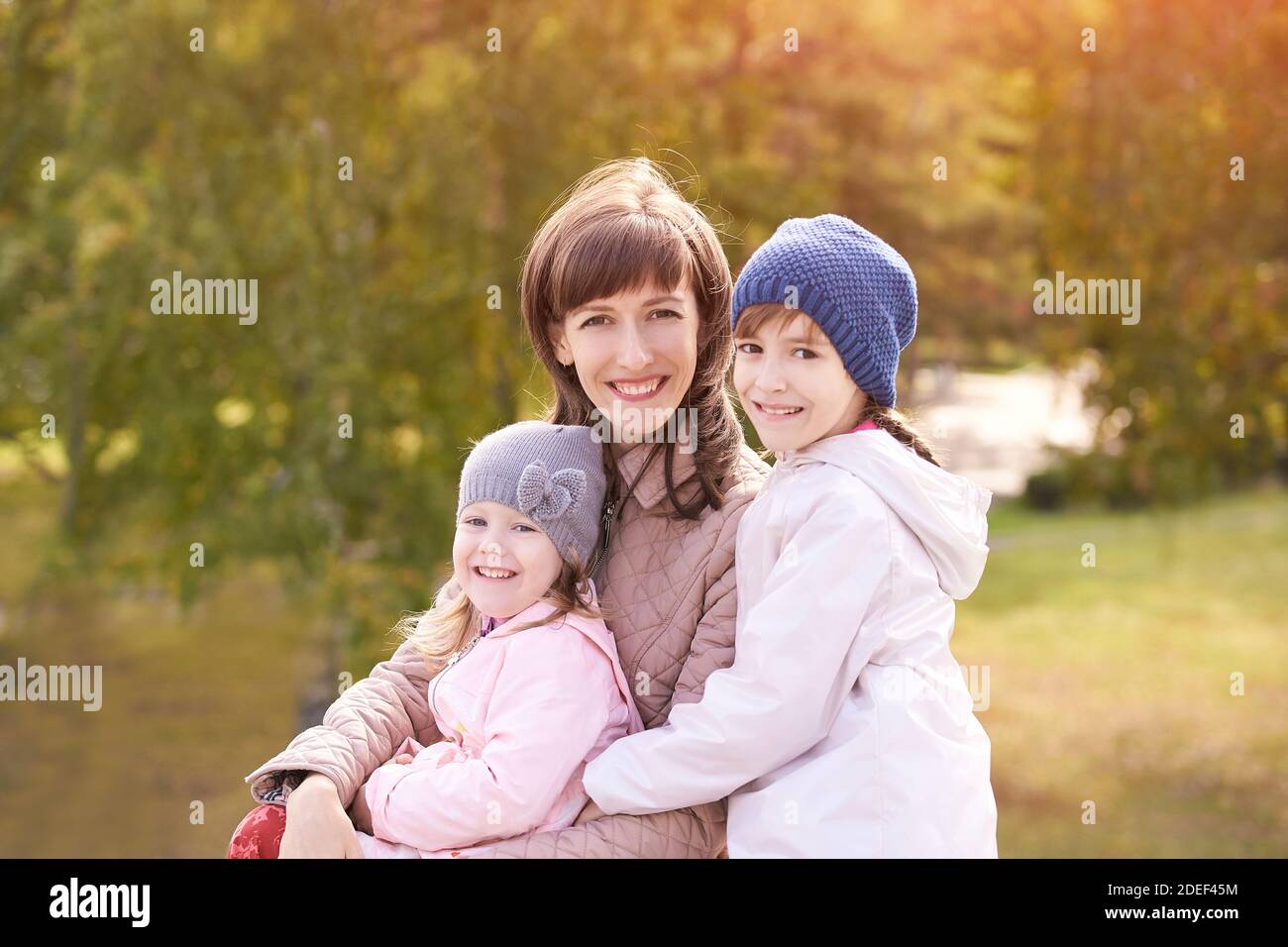 Smiling mother with two Daughter. Outdoors family portrait Stock Photo ...