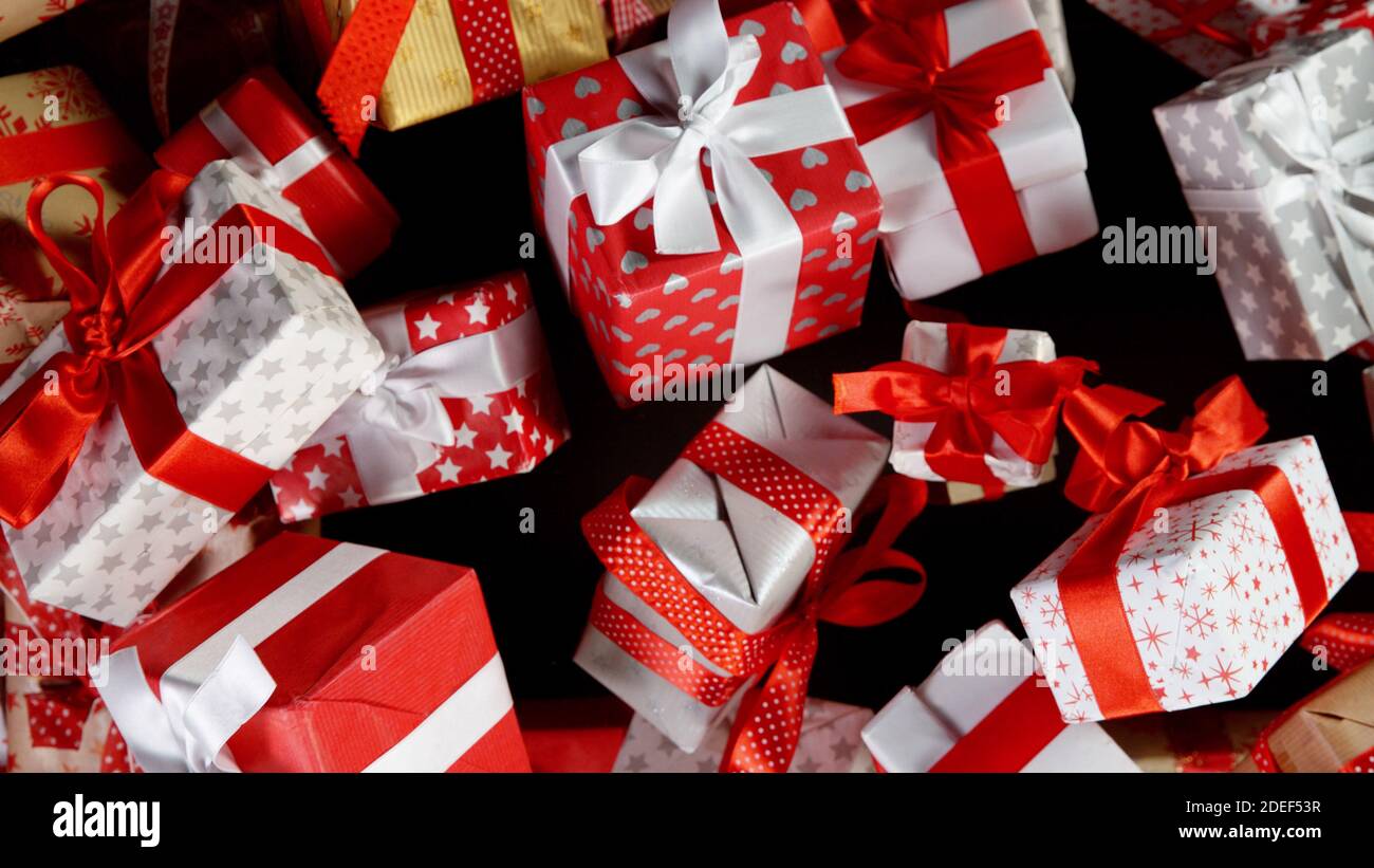 Flying christmas gifts on black background, concept of celebrating ...