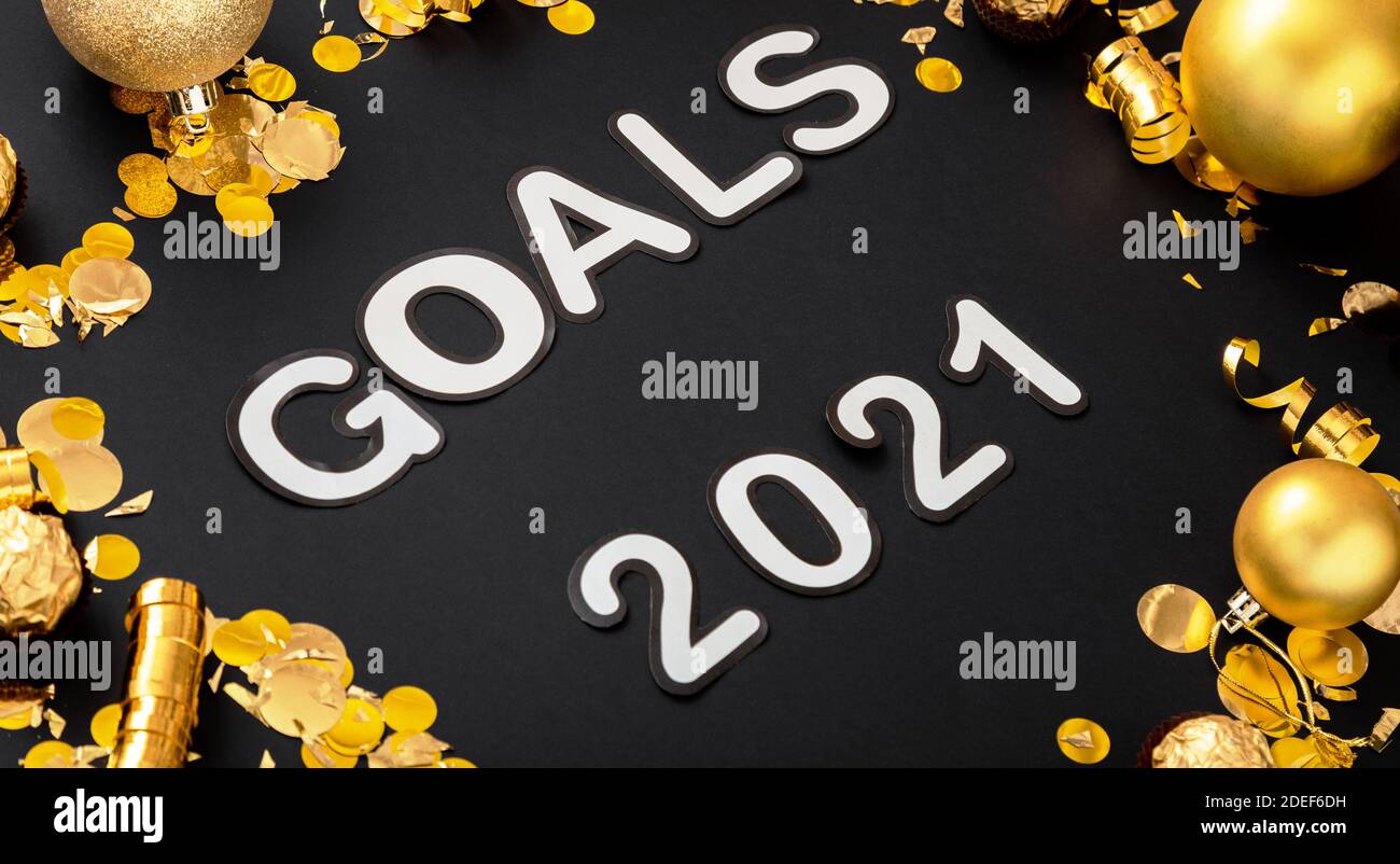 Goals 2021 text lettering on black background in frame made of gold ...