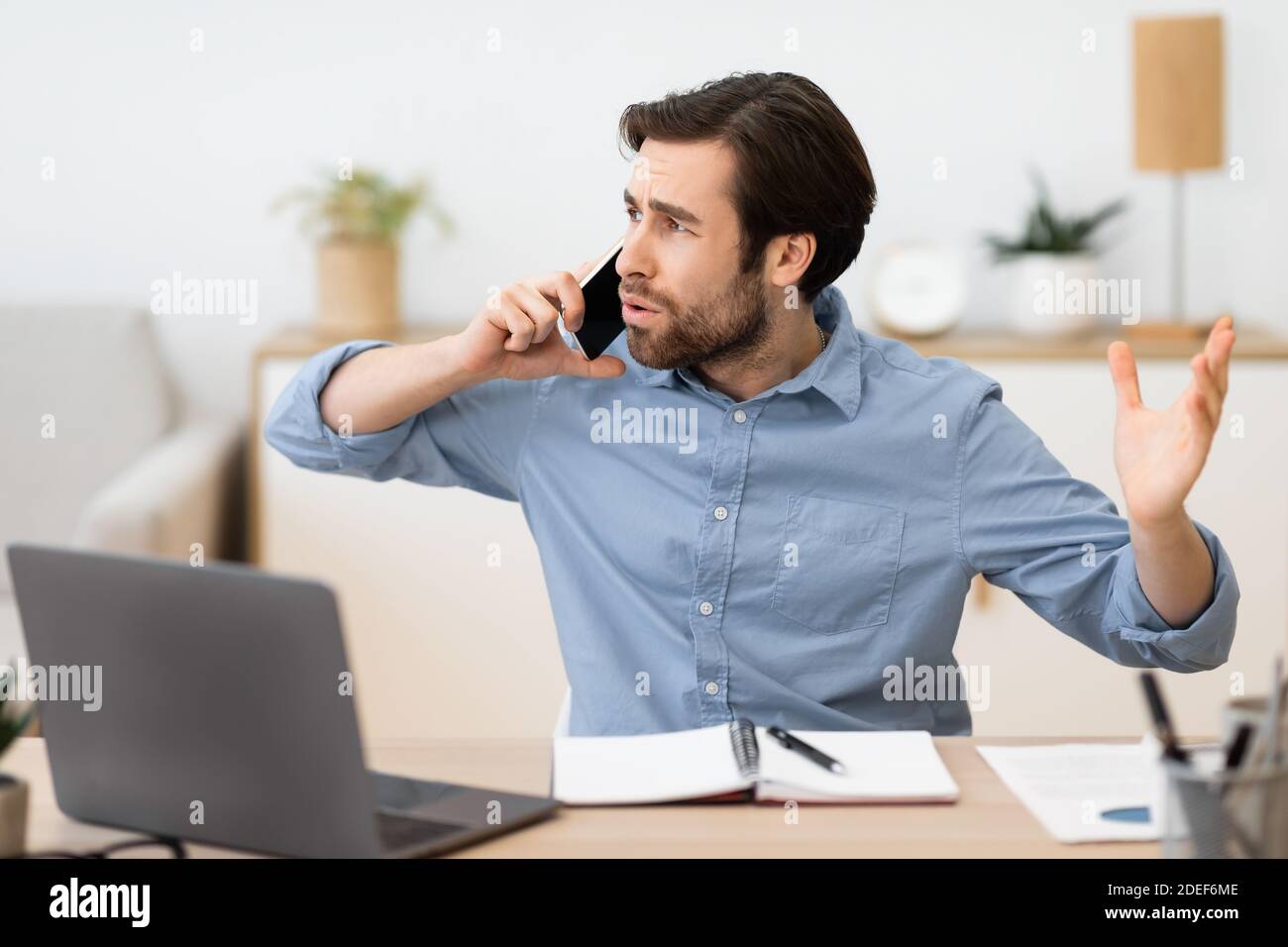 Angry Businessman Calling By Phone Having Problems Sitting At Workplace ...