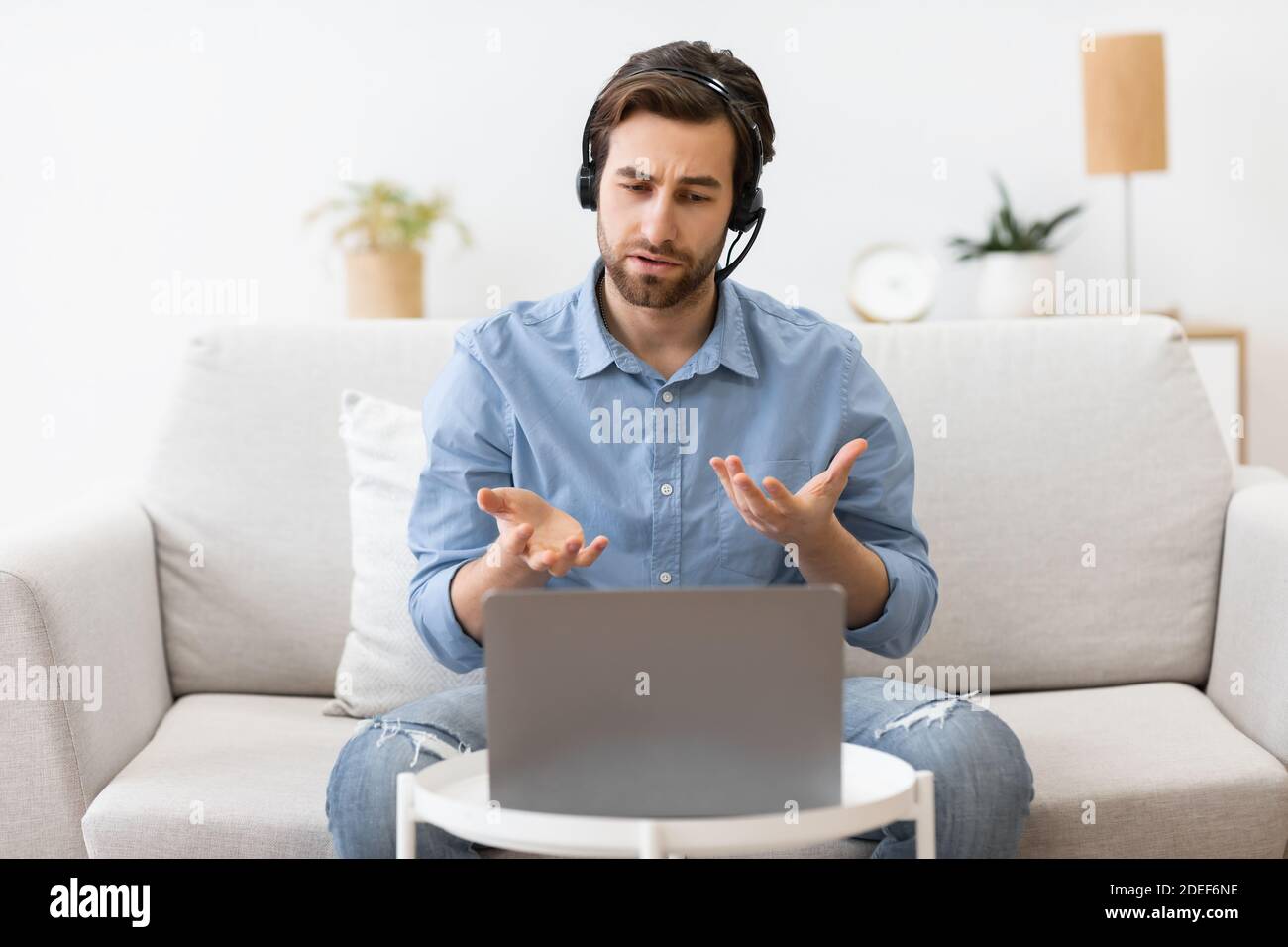 Guy In Headphones At Laptop Making Video Call At Home Stock Photo - Alamy
