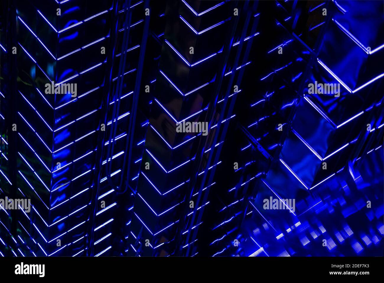 Abstract dark high-rise building at night, modern glass wall with ...