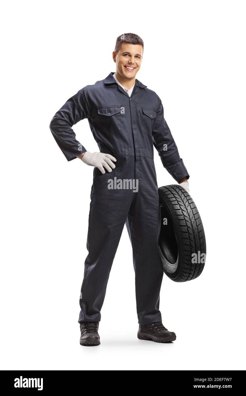 Full length portrait of an auto mechanic worker holding a car tire and ...