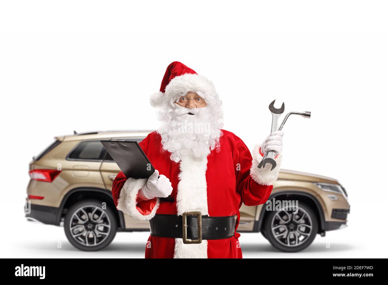 Cheerful santa claus holding car repair tools isolated on white ...