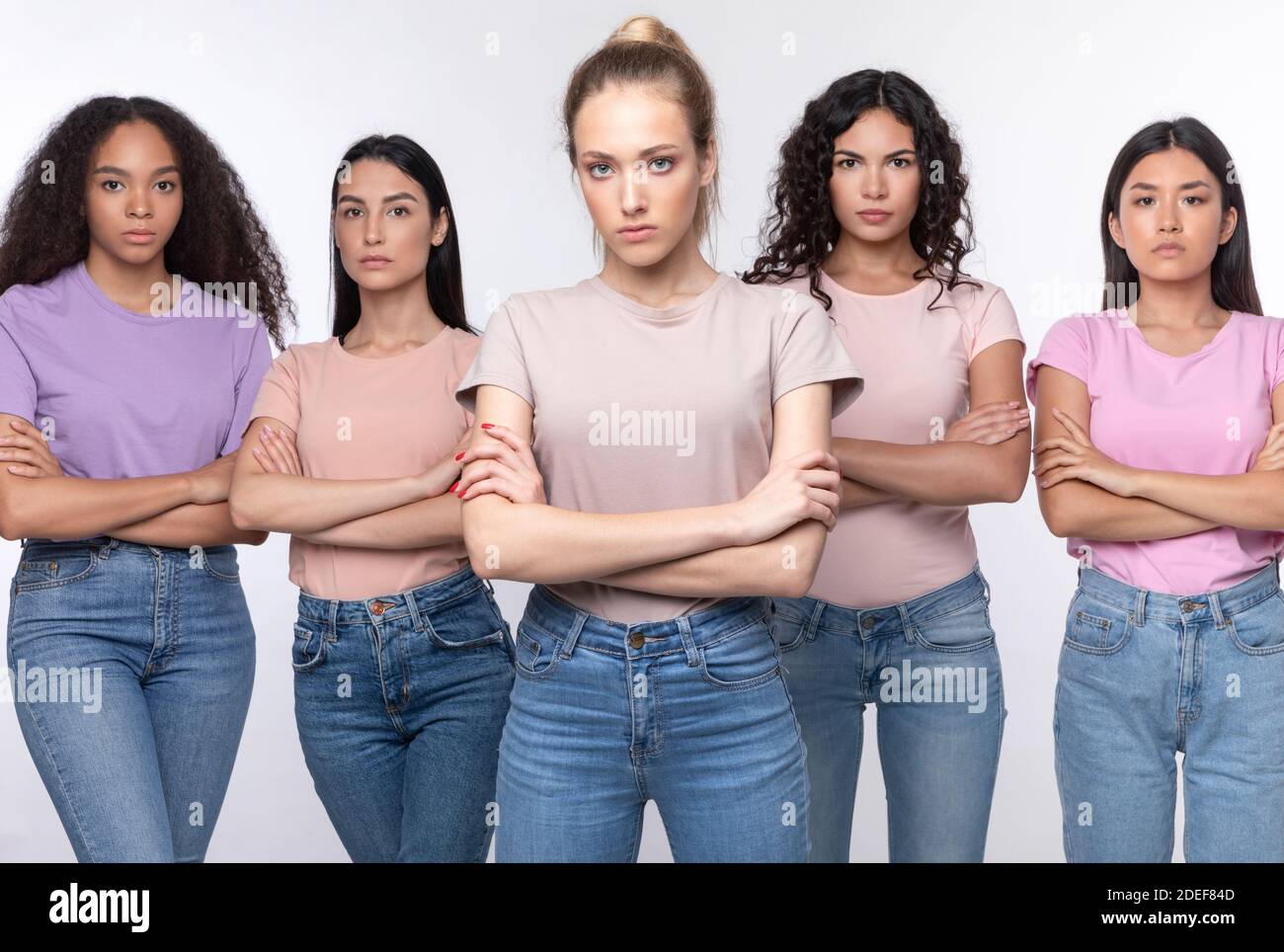 Displeased Mixed Women Standing Crossing Hands Over White Background ...