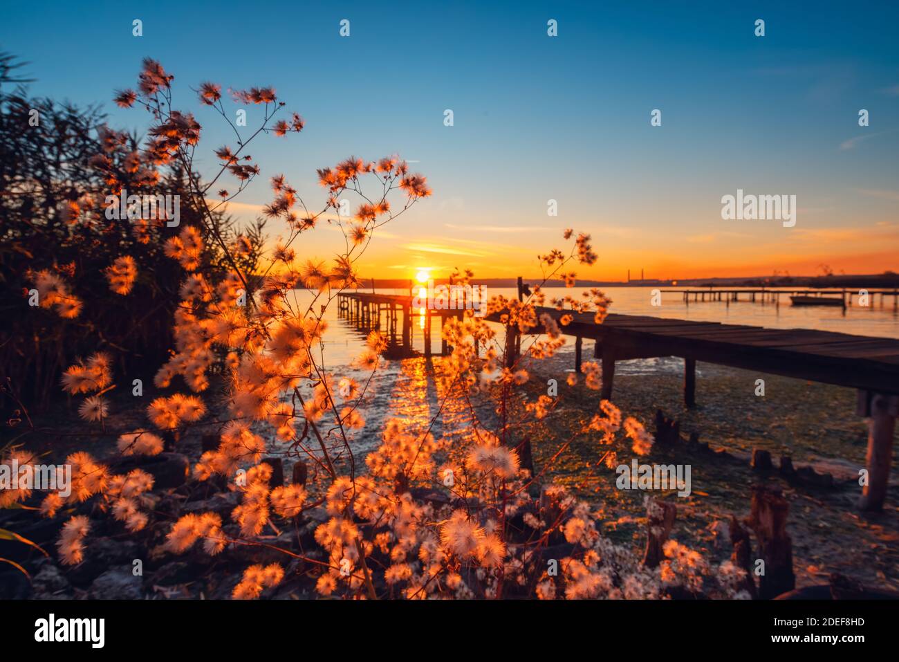 Small Dock and Boat at the lake, sunset shot Stock Photo - Alamy