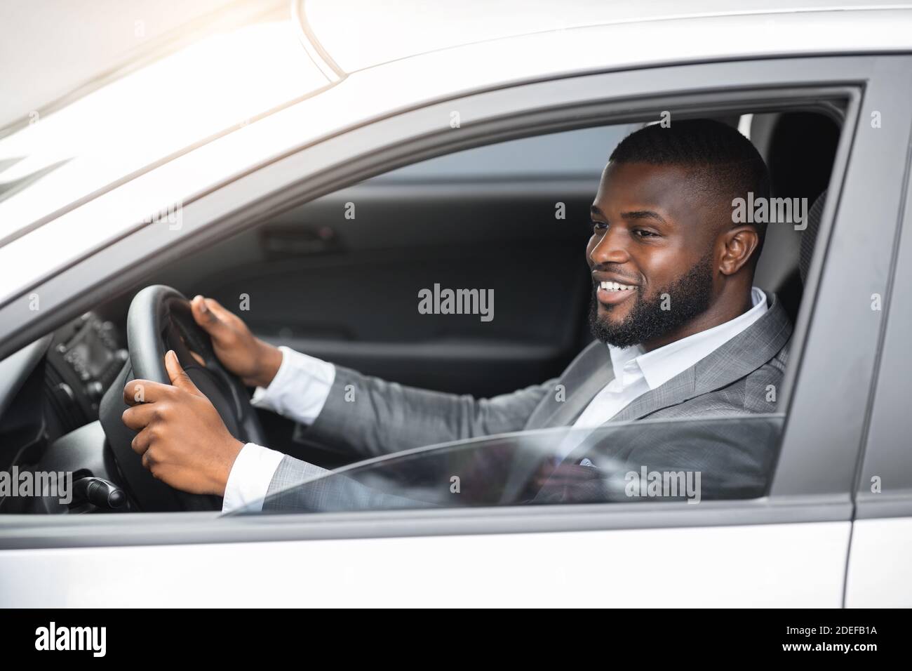 African american young man in suit driving car Stock Photo - Alamy