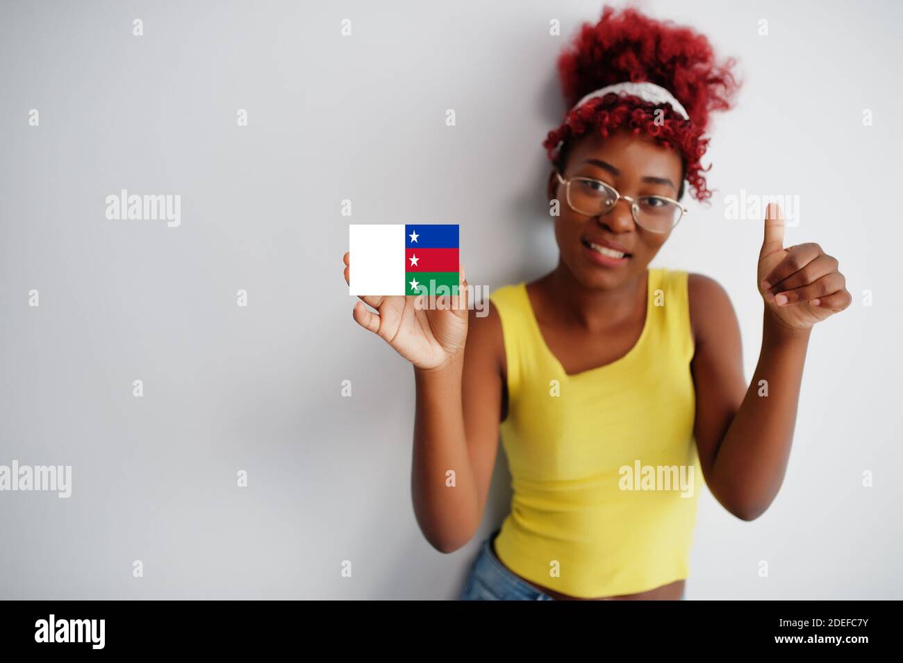 African woman with afro hair hold Bayelsa flag isolated on white ...