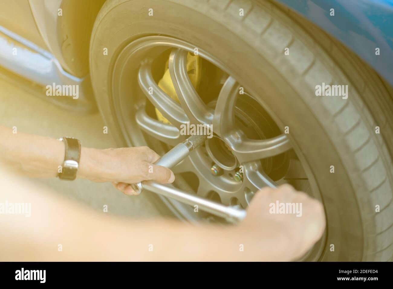 having some car issues on the roadside highway, man fix the auto wheel ...
