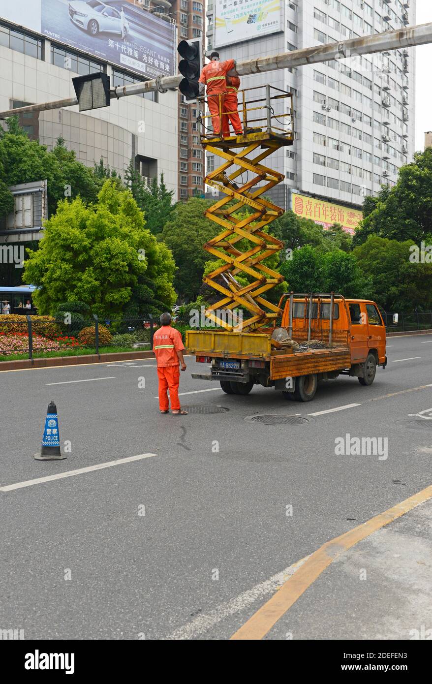 Workmen mend traffic lights in Guiyang city, Guizhou province, China ...