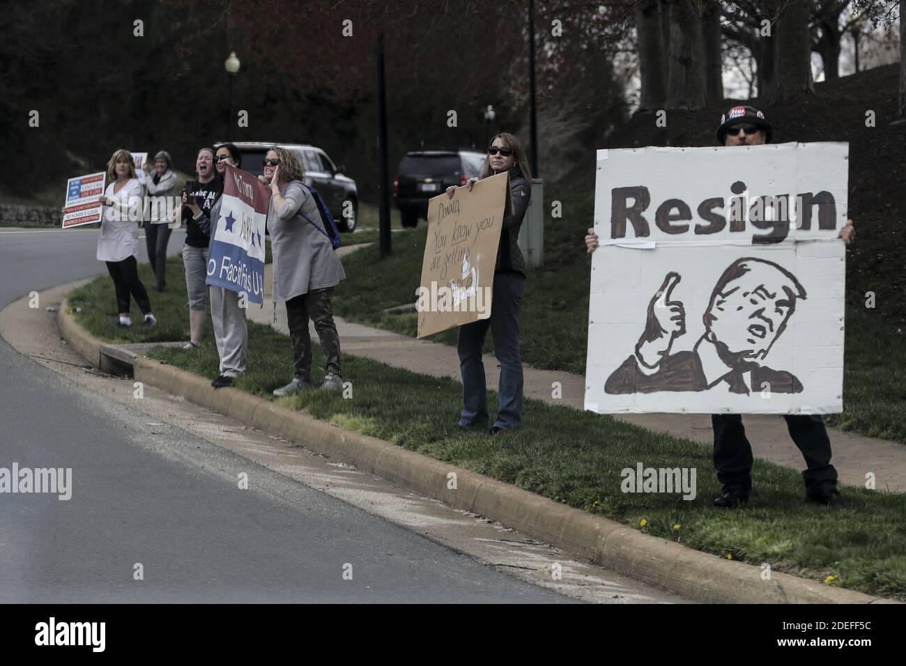 People carrying signs, protest as President Donald J. Trump motorcade ...