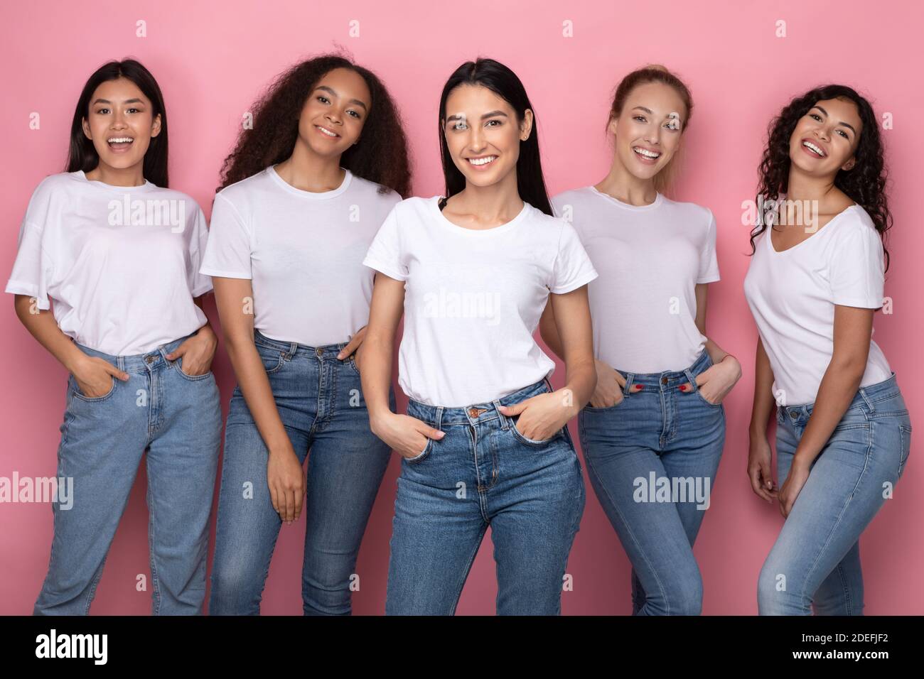 Five Pretty Mixed Young Ladies Standing On Pink Background Stock Photo ...