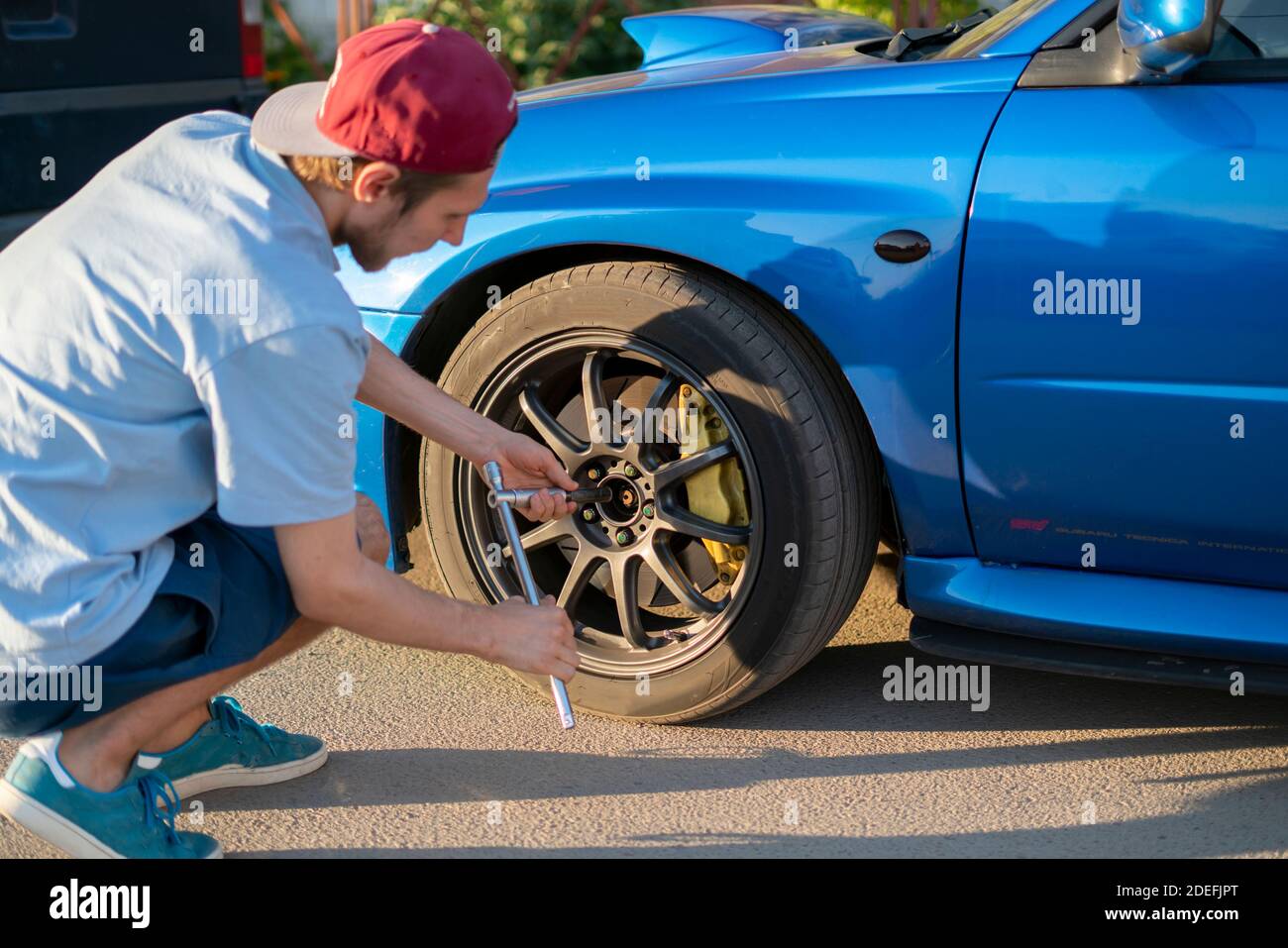 having some car issues on the roadside highway, man fix the auto wheel ...