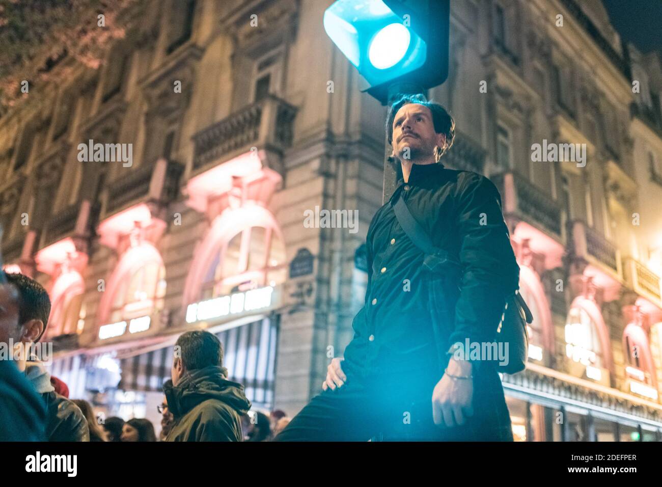 Worshippers pray as firefighters battle to extinguish a giant fire that ...