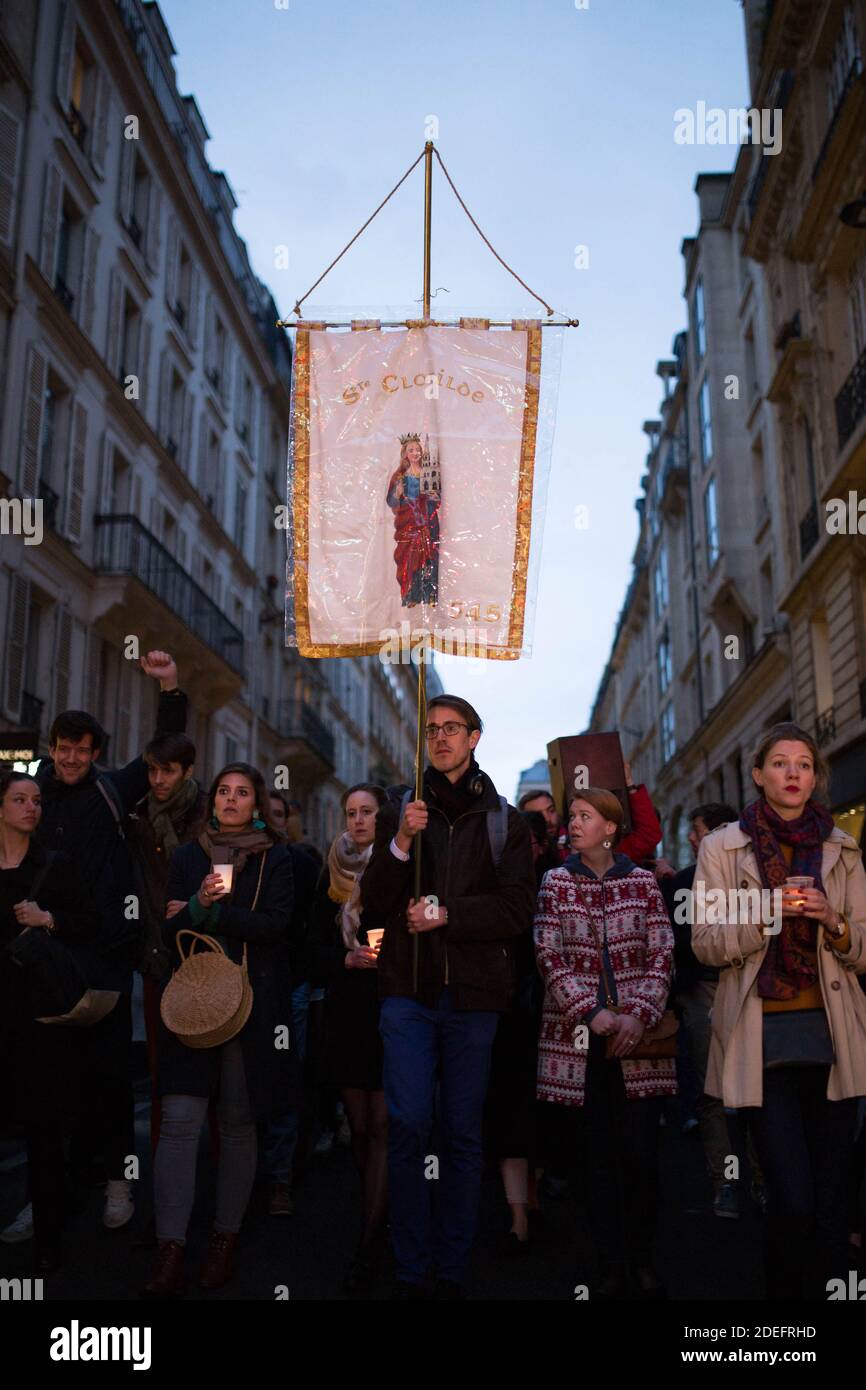 People praying with candles and holding a saints Clotilde sign during ...